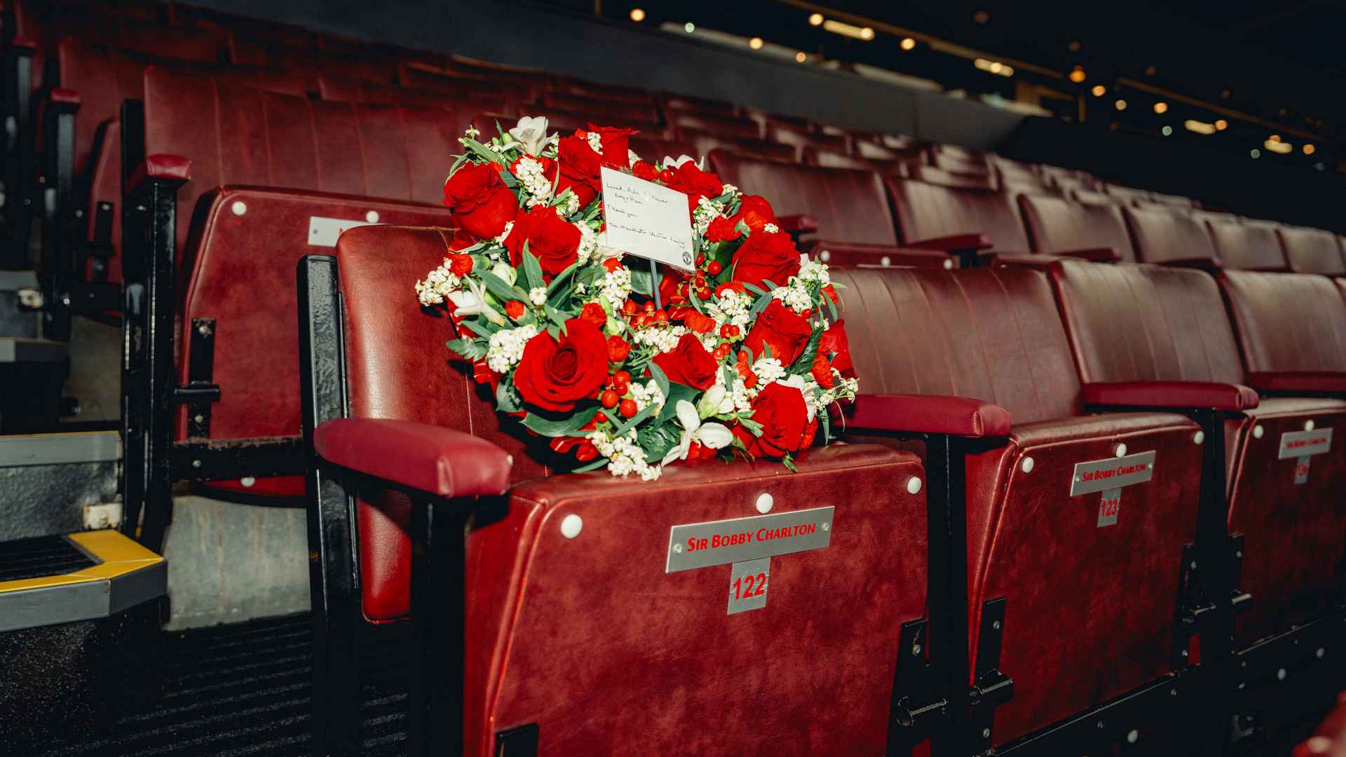 Richard Arnold lays wreath on Sir Bobby Charlton seat in directors box ...